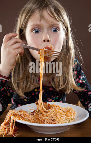 Girl eating messily Stock Photo - Alamy