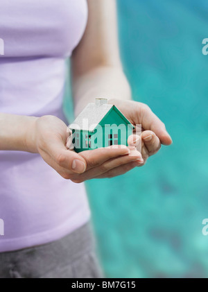 Small toy house in hands Stock Photo - Alamy