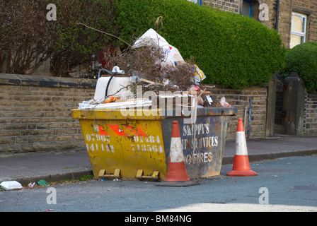 Overloaded skip on a building site - waste segregation Stock Photo - Alamy
