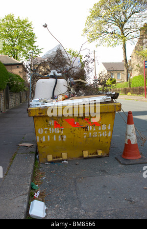 Overloaded skip on a building site - waste segregation Stock Photo - Alamy