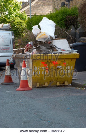 Overloaded skip on a building site - waste segregation Stock Photo ...