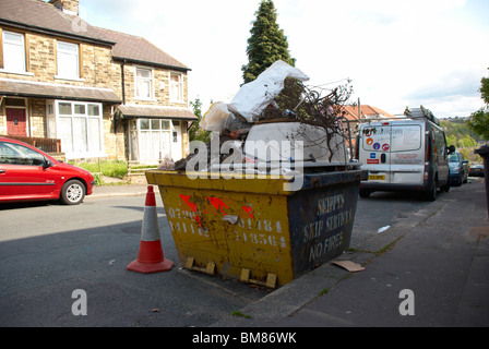 Overloaded skip on a building site - waste segregation Stock Photo - Alamy