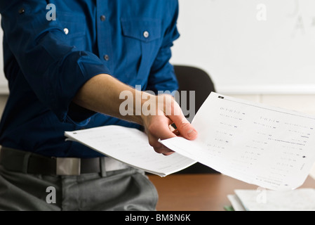 Handing out test papers Stock Photo - Alamy