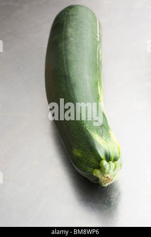 Single courgette or zucchini on a plain white background. Copy space ...