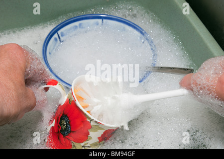 washing up bowl with utensils Stock Photo - Alamy
