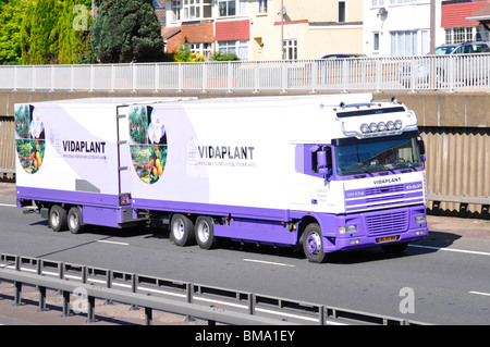 Front & side view of tow trailer & unmarked hgv flatbed lorry truck ...