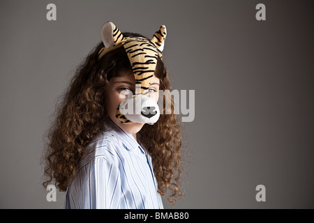 Young girl wearing tiger mask Stock Photo - Alamy