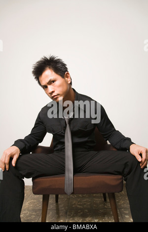 black intimidating man sitting with hands forward white background ...