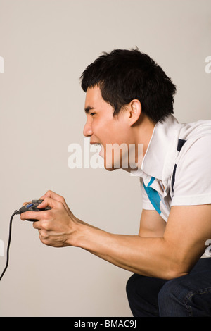 happy young man playing video games at night Stock Photo - Alamy