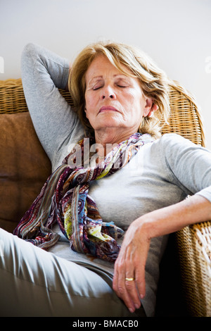 Tired older woman resting taking afternoon nap Stock Photo - Alamy