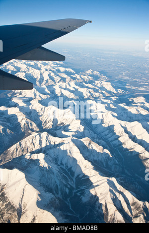 View of airplane wing, blue skies and green land during landing ...