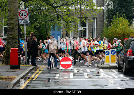 London Marathon runners running along Charlton Way, Blackheath, London ...