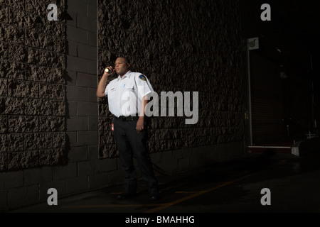 Security guard patrols with torch Stock Photo - Alamy