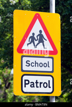 A school patrol slow down road sign Stock Photo - Alamy