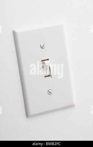 White plastic light switch on turquoise background Stock Photo - Alamy