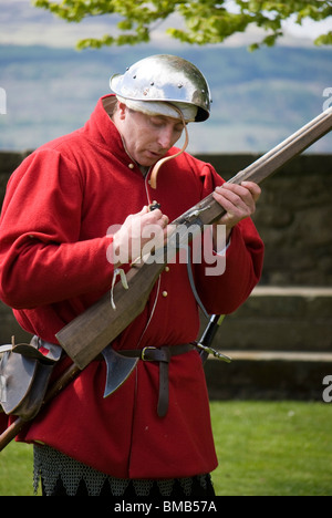16th century Scottish Soldier of the Guard firing a fuselock rifle ...