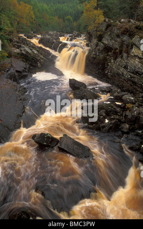 Peat coloured water flowing over a waterfall formed by the inclined ...