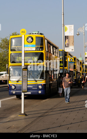 Yellow and Blue painted Dublin bus and city tour bus on O'Connell ...