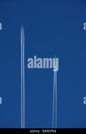 Commercial jet contrails vapor Stock Photo - Alamy