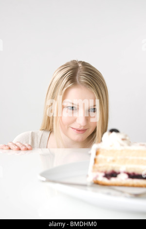 Woman Staring at Piece of Cake Stock Photo - Alamy