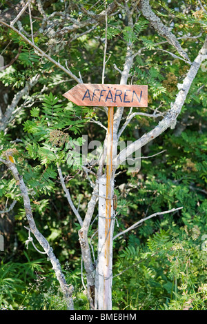 Sign post in the woods, both directions, two way Stock Photo - Alamy