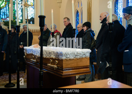 Mourners file past the coffin of Cardinal Cahal Daly as he lies in ...