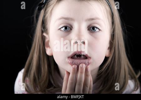 Shot of an Upset Child with Gaps in her Teeth Stock Photo - Alamy