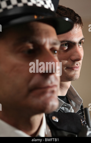 serious male police officer in bulletproof vest taking off sunglasses ...