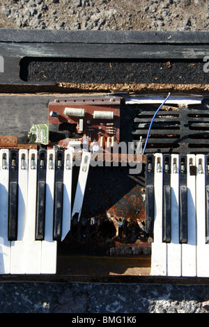 old music synthesizer piano damaged in street Stock Photo - Alamy