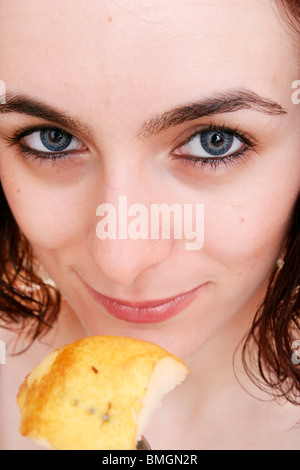 Woman eating tasty pear with fork Stock Photo - Alamy