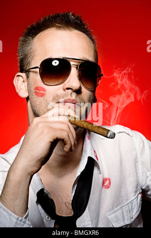 Man Smoking Cigar with Lipstick Kiss on Cheek Stock Photo - Alamy