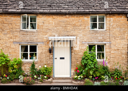 The pretty front door and windows of a typical English country cottage ...