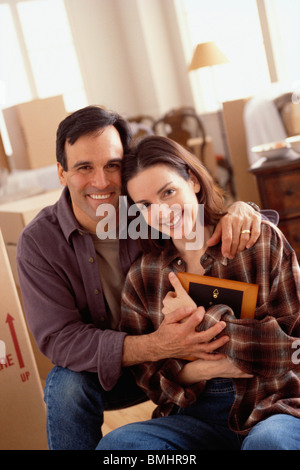 Young pair moving in to new house with boxes Stock Photo - Alamy