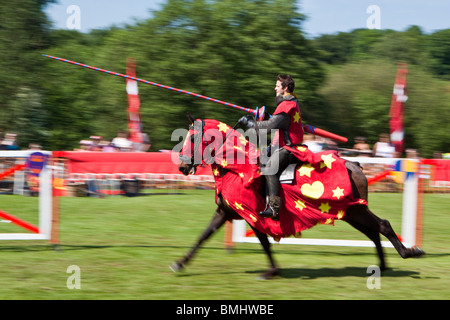 Knight on horse charging at a joust Stock Photo - Alamy