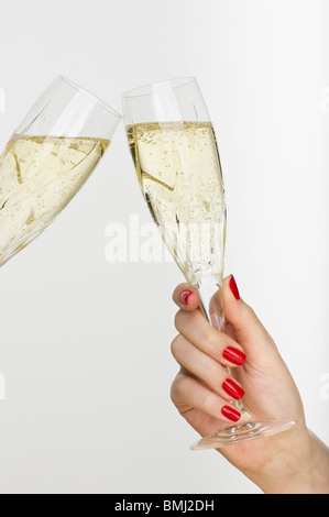 Hand holding champagne glass Stock Photo - Alamy
