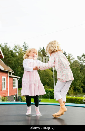 Happy little girl jumping on trampoline in fitness center Stock Photo ...