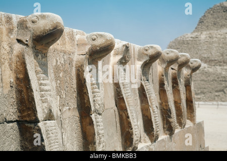 The line of cobra statues at The Step pyramid of Djoser, Saqqara, Egypt ...