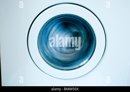 White laundry spins in washing machine drum with water Stock Photo - Alamy