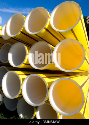 Infrastructure maintenance yellow plastic gas main pipe stacked on ...