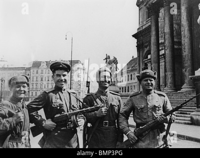 VIENNA 1945 Red Army soldiers stand guard beside a poser of Stalin ...