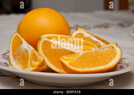 Close-up of juicy sliced Oranges served on a white Plate Stock Photo ...