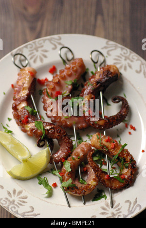 Grilled squid or calamari on skewer.Barbecue squids on a plate Stock ...