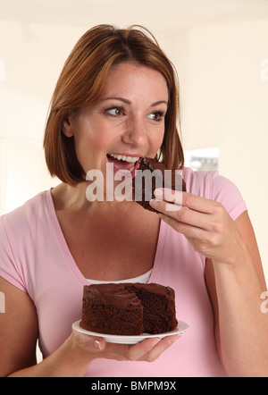 Fat woman eating cake Stock Photo - Alamy