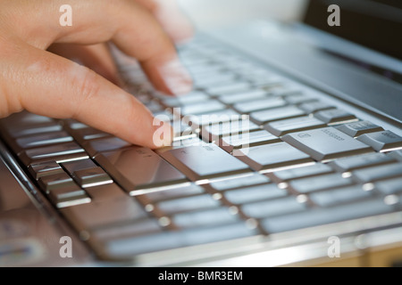 Hands typing on laptop keyboard close up on pink Stock Photo - Alamy