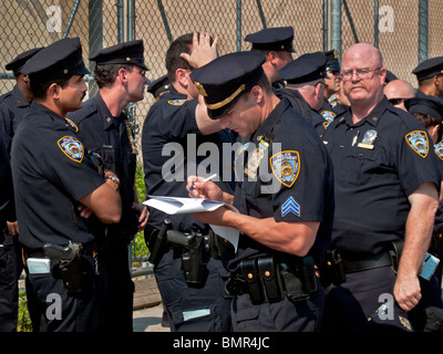 Police officers receive assignments at the beginning of their shift in ...