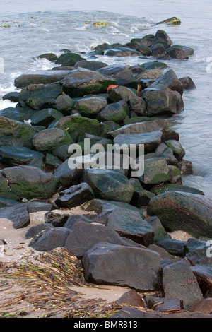 Granite rock groynes protect the beach at Felixstowe Suffolk from ...