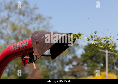 wood chipper head disgorging chipped branches Stock Photo - Alamy