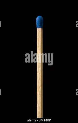 A single blue-tipped safety match inside an open matchbox; on white ...