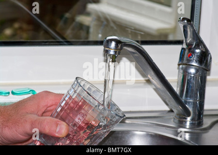 filling a glass of water from tap Stock Photo - Alamy