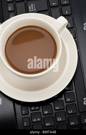 White keyboard and cup of coffee Stock Photo - Alamy